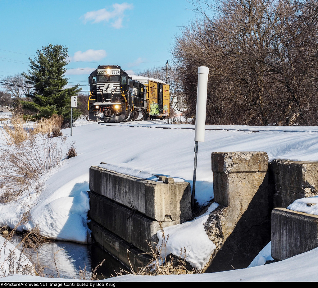 Returning westbound at MP 21 with a single box car